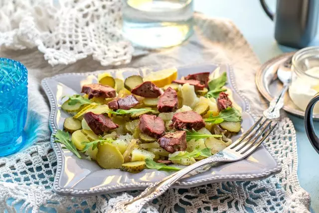 Salad with salt cucumber and liver