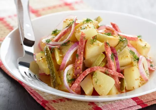 Salad with salty cucumbers and smoked sausage