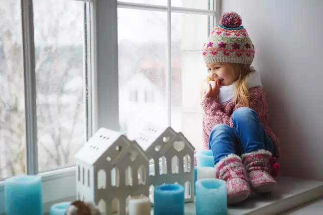 Girl looks out the window